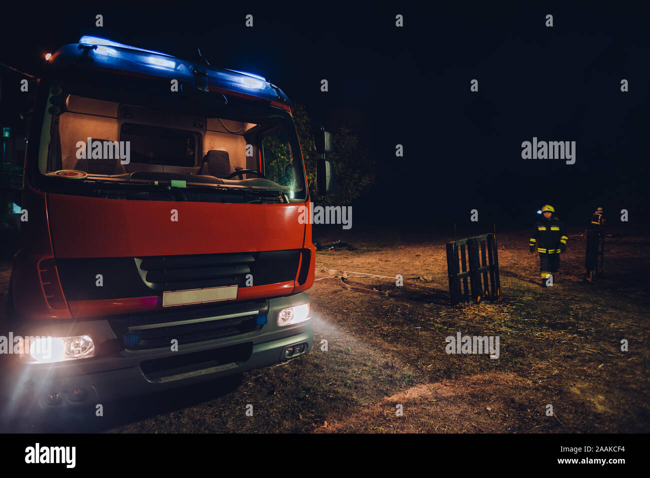 Firefighting vehicle in action at the area hit by fire Stock Photo - Alamy