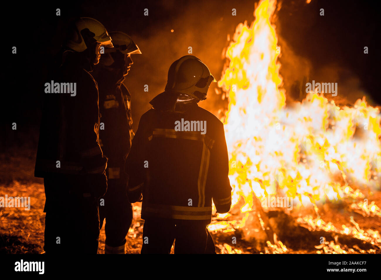 Firemen preparing the fire truck equipment for extinguishing flames ...