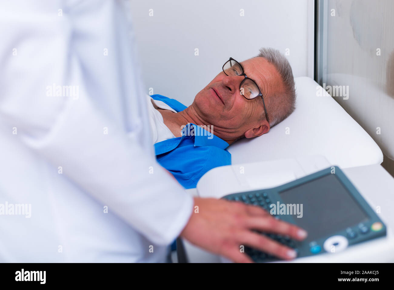 Close up of a Female (doctor) nurse performs an EKG test on an older ...