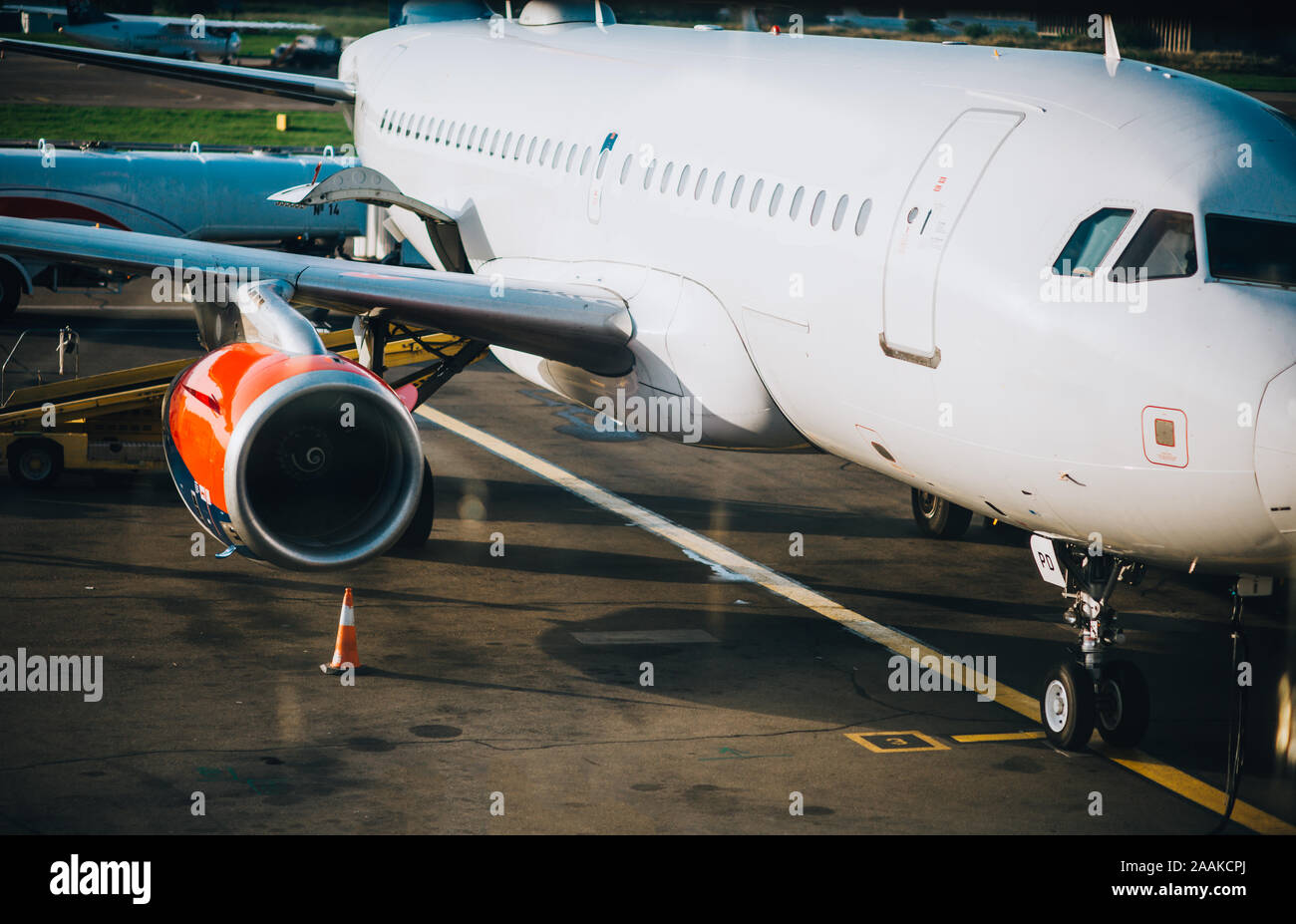 Airplane with jet engines being loaded with luggage at an international ...