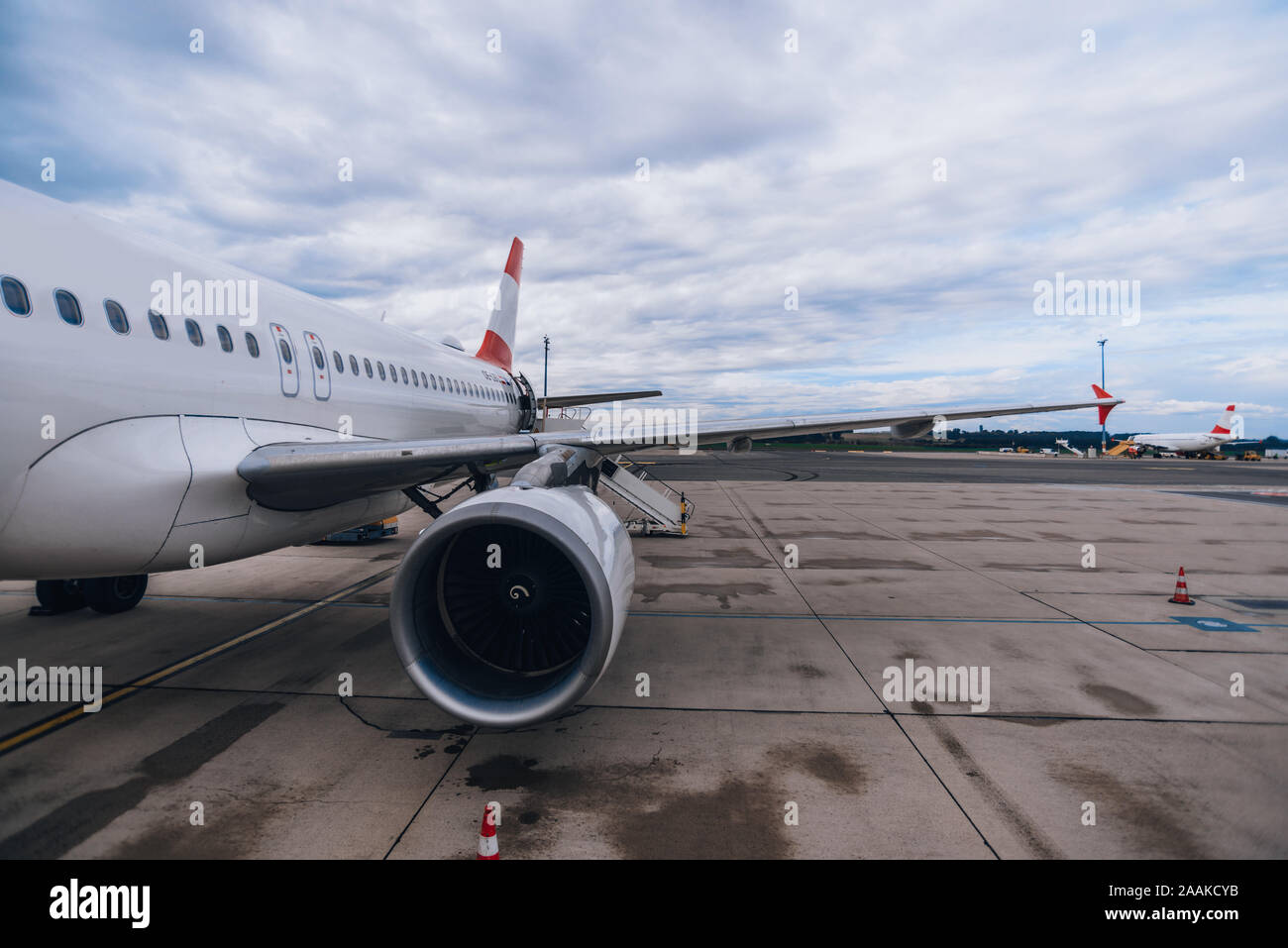 Airplane with jet engines and passenger boarding stairs at an aerodrome ...