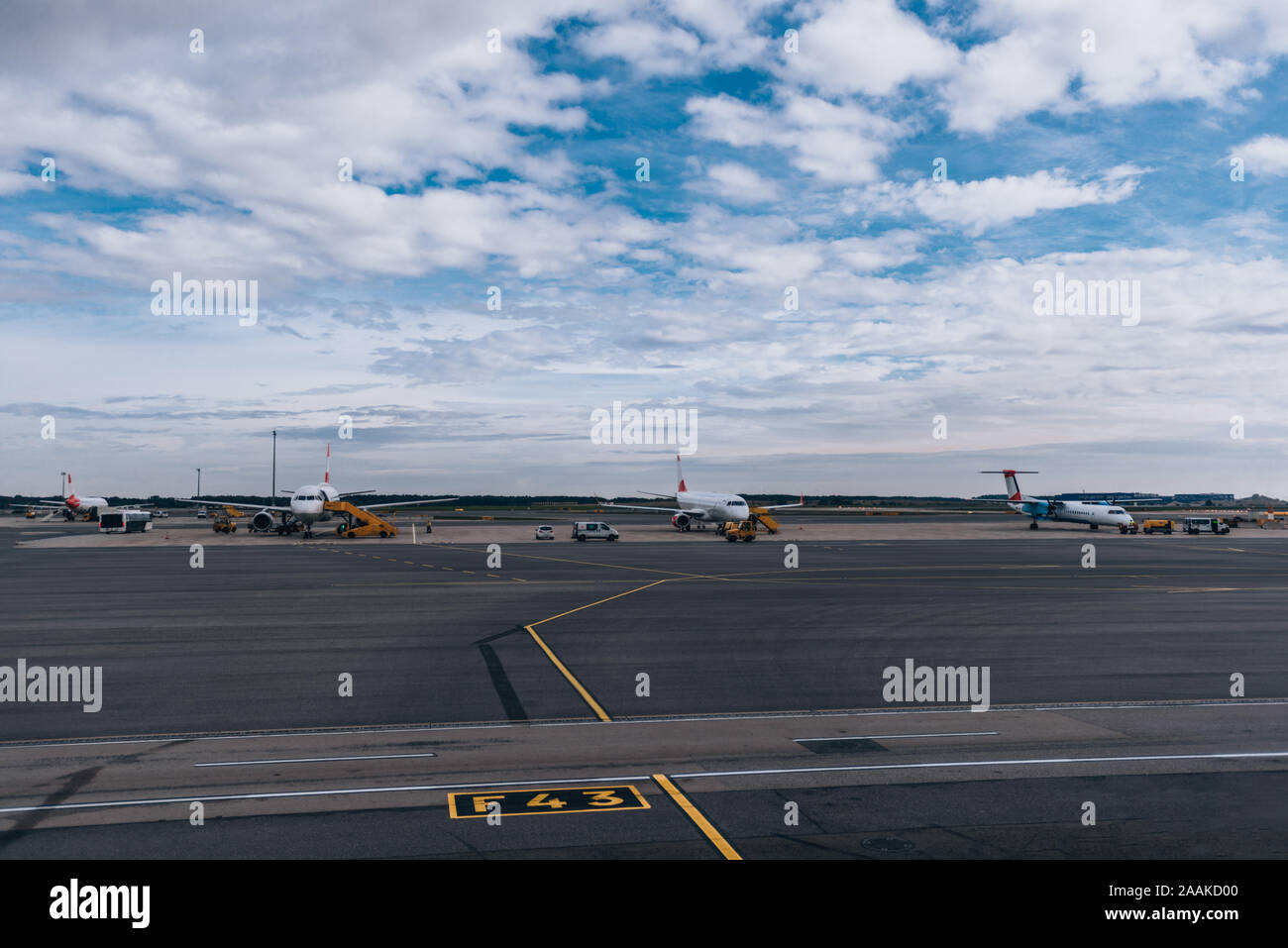 Two jet engine airplanes and one propeller engine airplane at an ...
