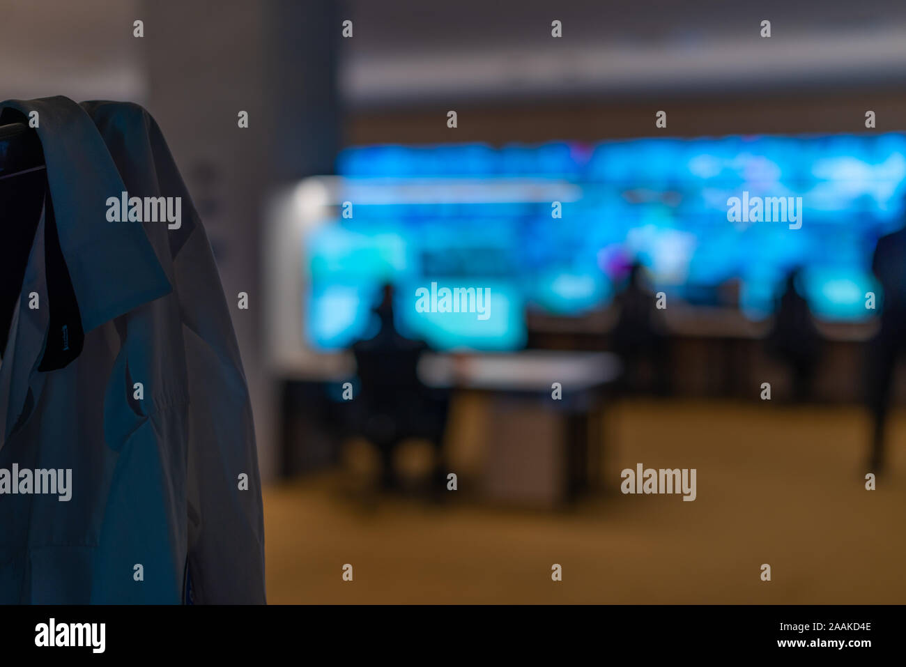 Blurred photo of security guards working on computers while sitting in ...