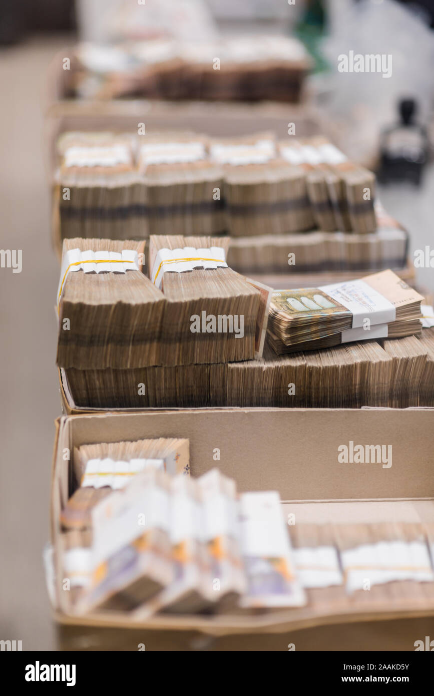Vast amount of cash divided and sorted with currency bands and placed ...
