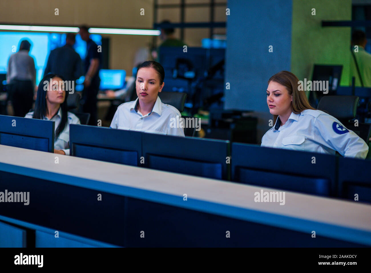 Security guard monitoring modern CCTV cameras in a surveillance room ...