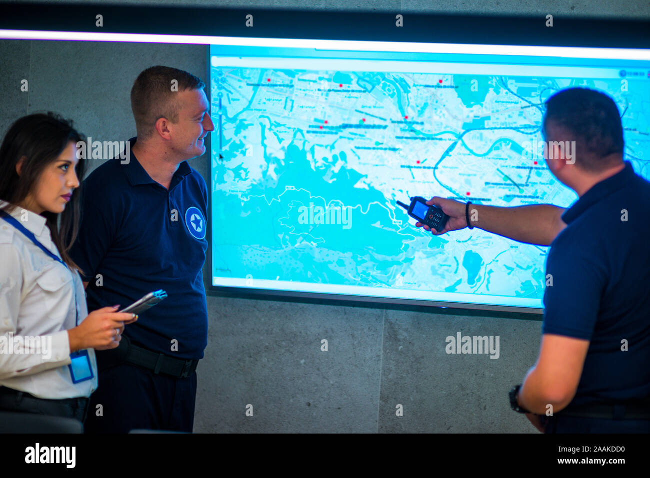 Security guards and policemen holdng portable transmitter having ...