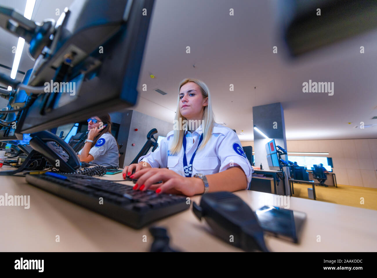 Female security operator working in a security data control room ...