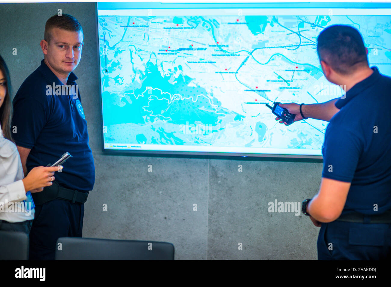 Security guards and policemen holdng portable transmitter having ...