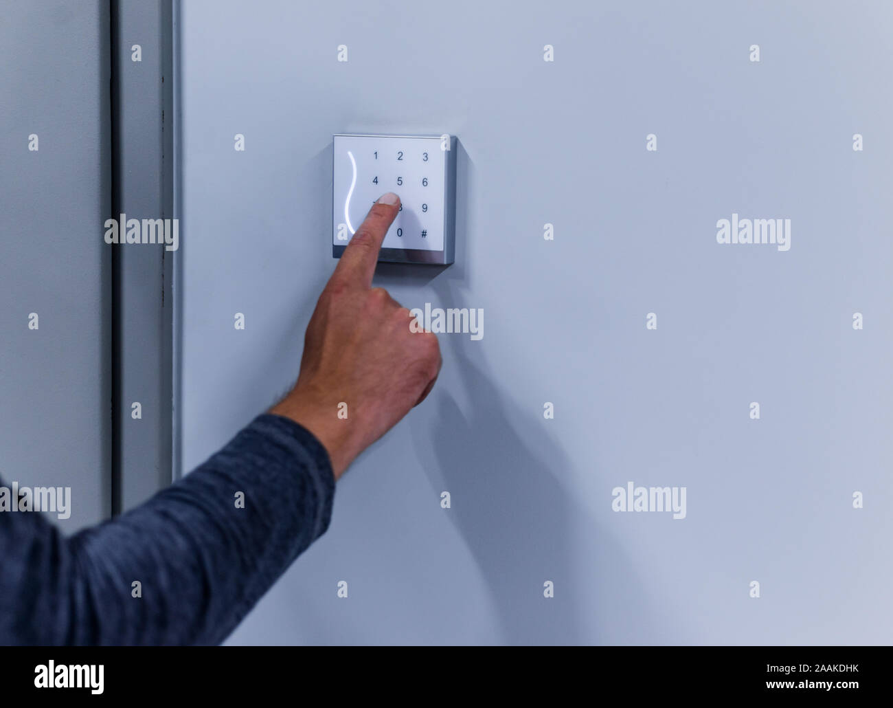 Man hand entering numeric passcode into keypad for providing access to the secured area Stock ...