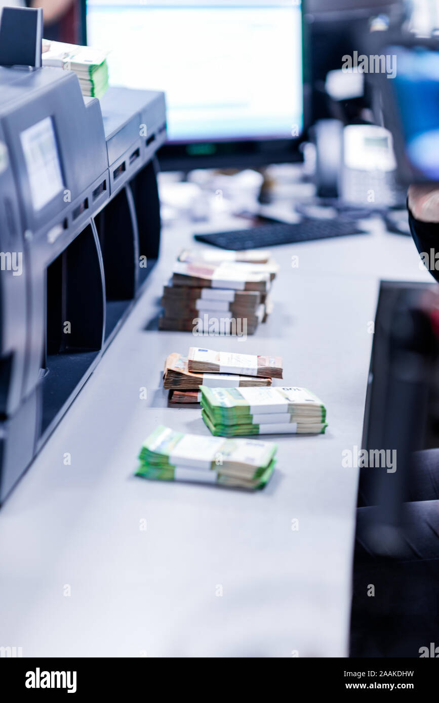 Bundles of € euro banknotes divided into groups with currency straps ...