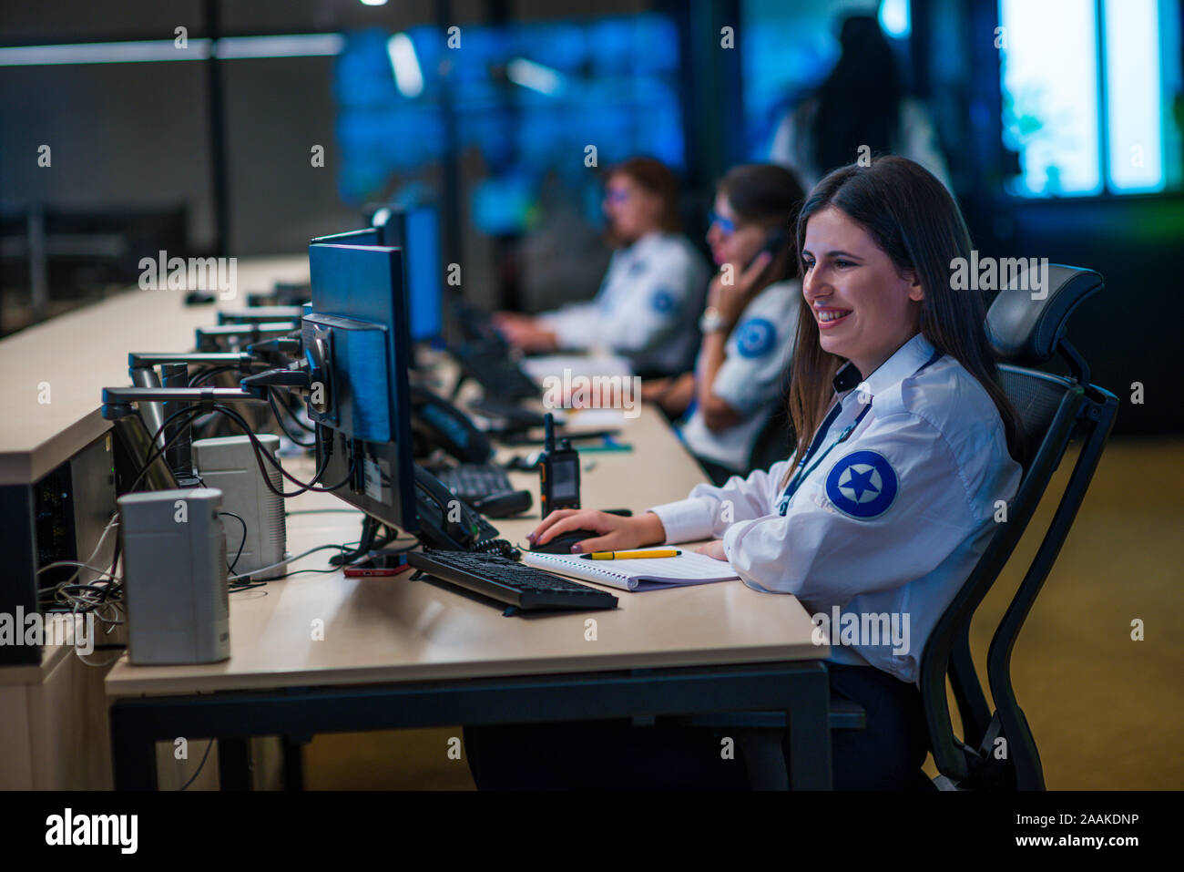 Security guard monitoring modern CCTV cameras in a surveillance room ...