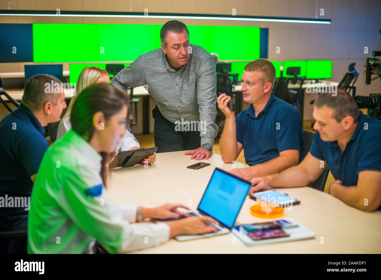 Security guard monitoring modern CCTV cameras in a surveillance room ...