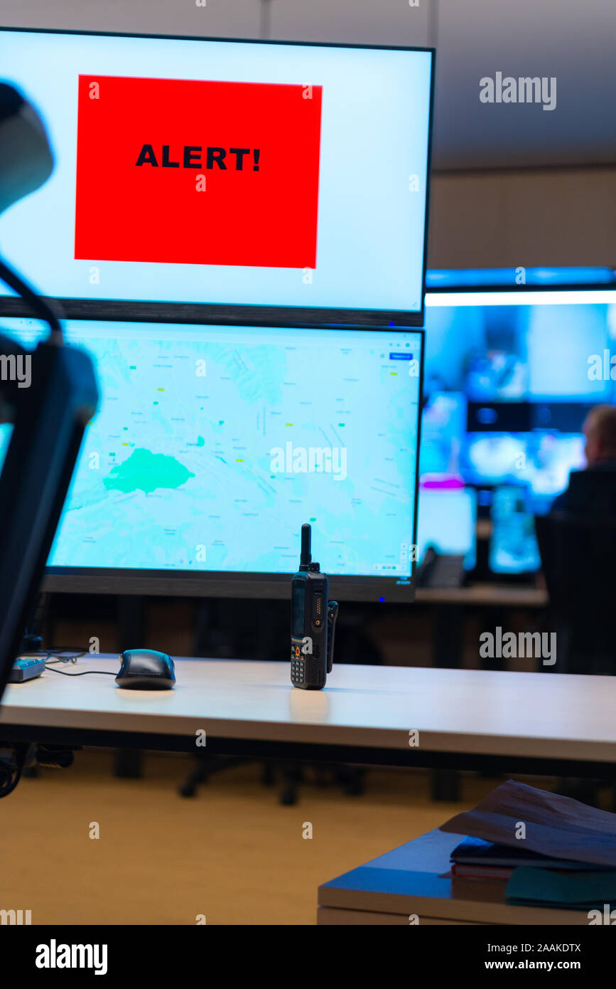 Close up photo of a walkie-talkie on an empty desk in front of a ...