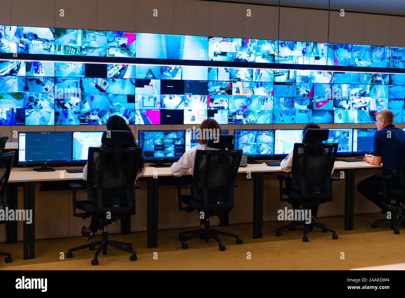 Team of secret agents in uniforms, monitoring cyber, video and ...