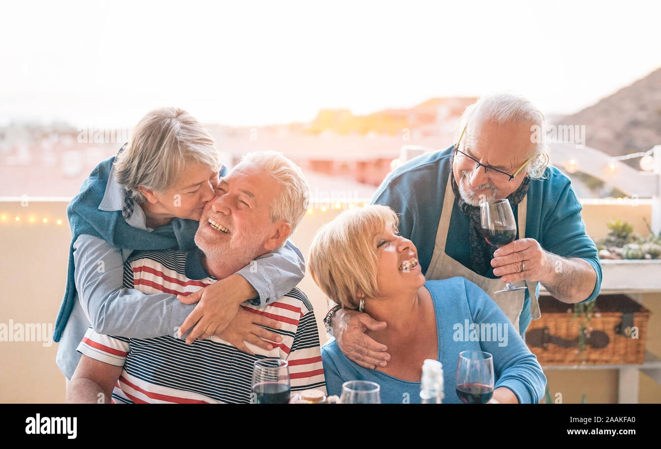 Happy seniors couple having fun dining together on terrace - Romantic ...