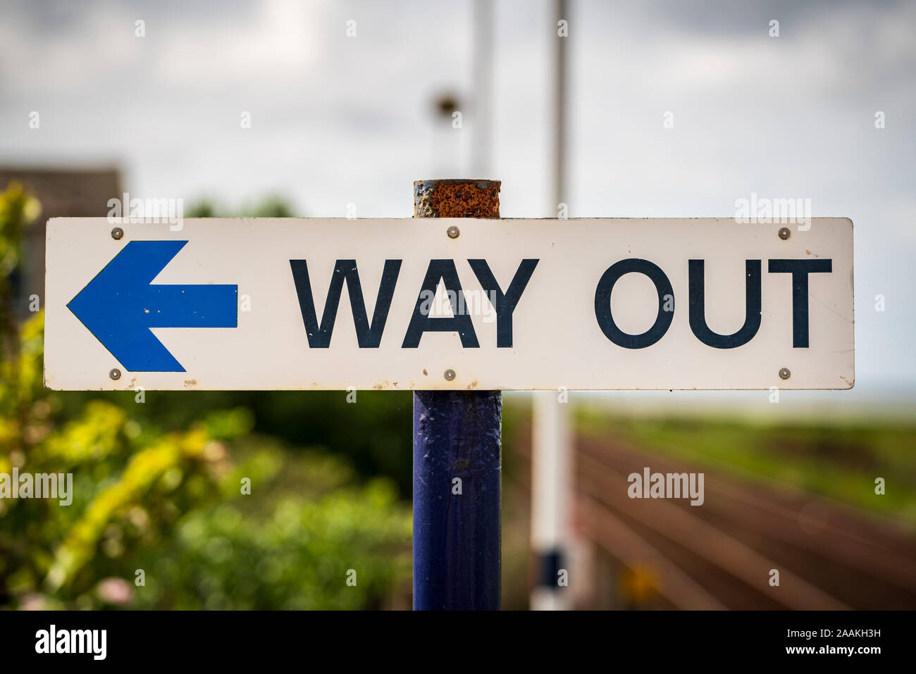 Sign: Way Out, with blurry background, seen in Kirkby-in-Furness ...