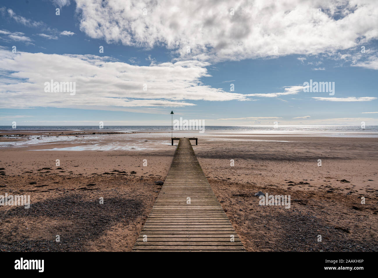The beach and a wooden walkway in Seascale, Cumbria, England, UK Stock ...