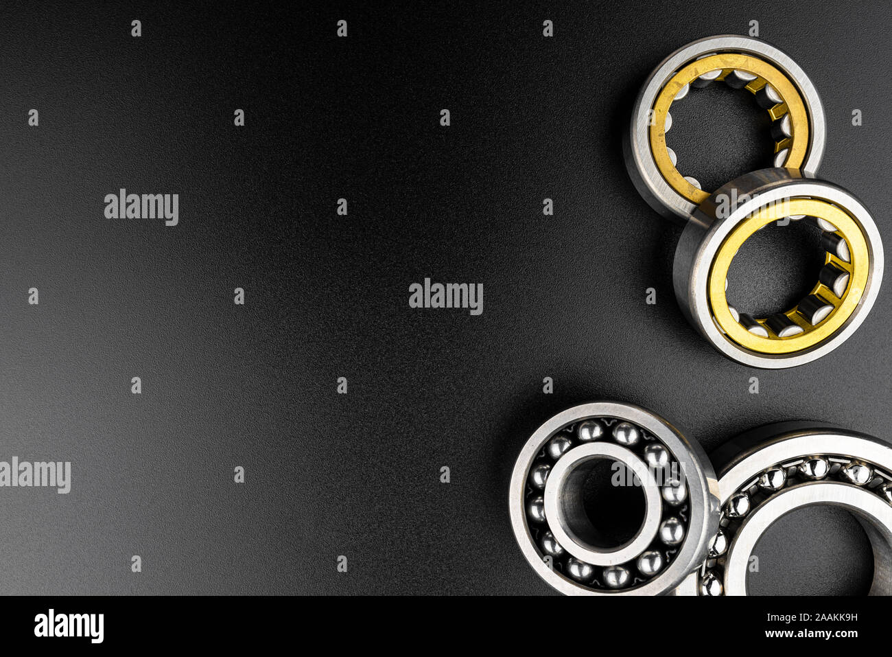 Ball bearing lying on a black background with copy space on the left ...