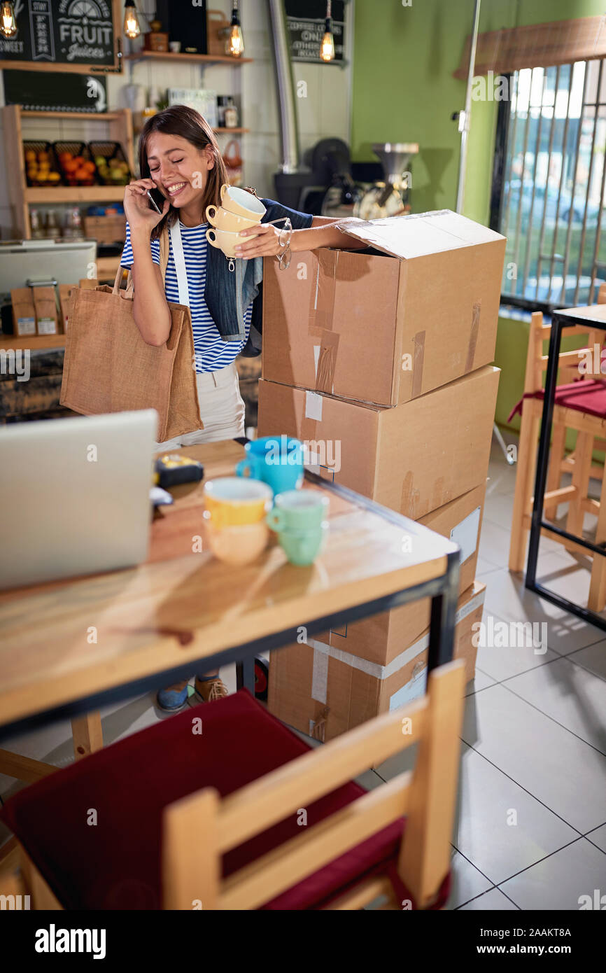 Happy girl working in coffee store Stock Photo - Alamy