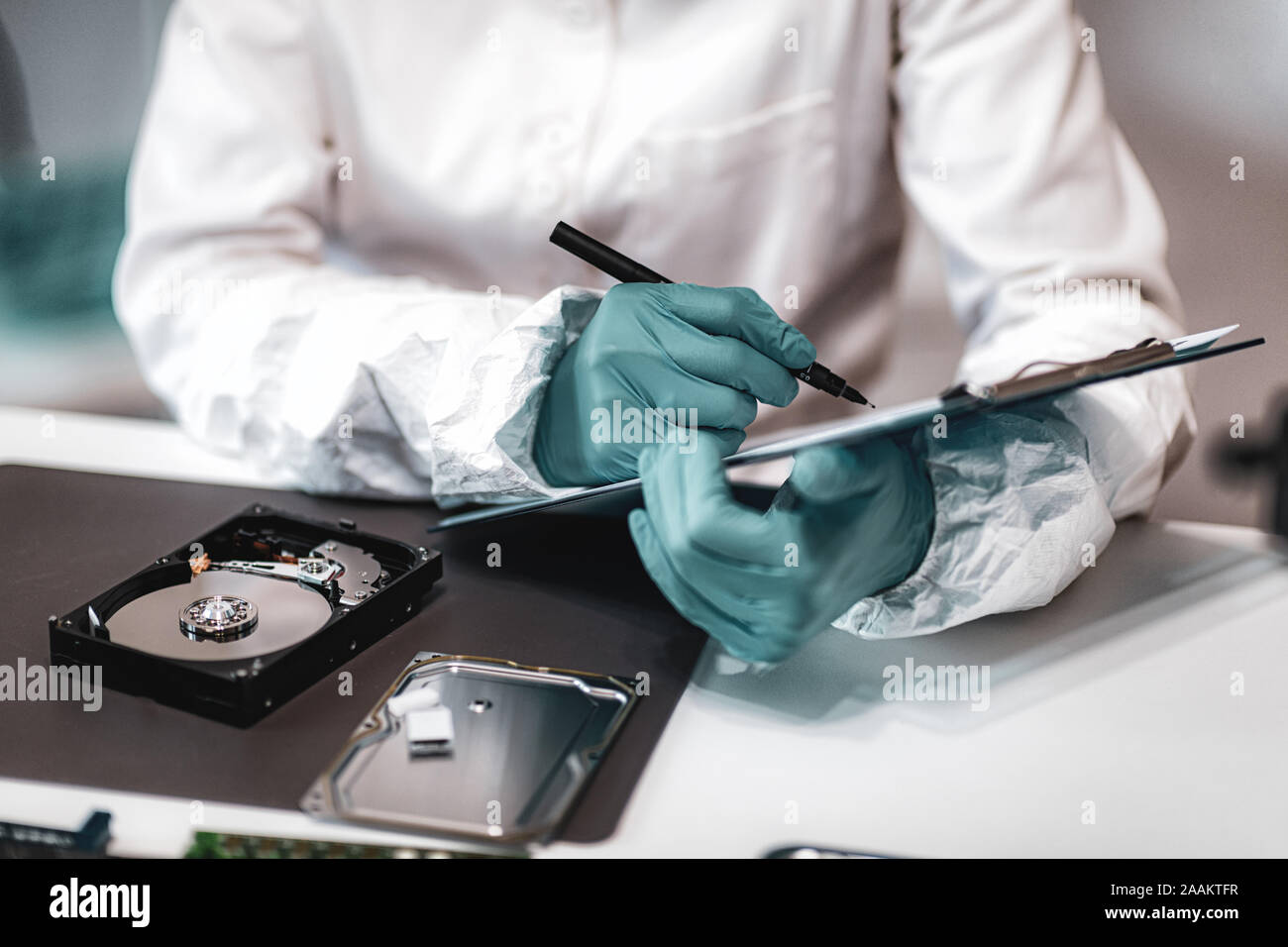 Forensic science technician examining computer hard drive Stock Photo ...
