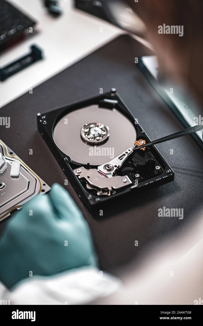 Forensic science data. Forensic analyst examining computer hard drive ...