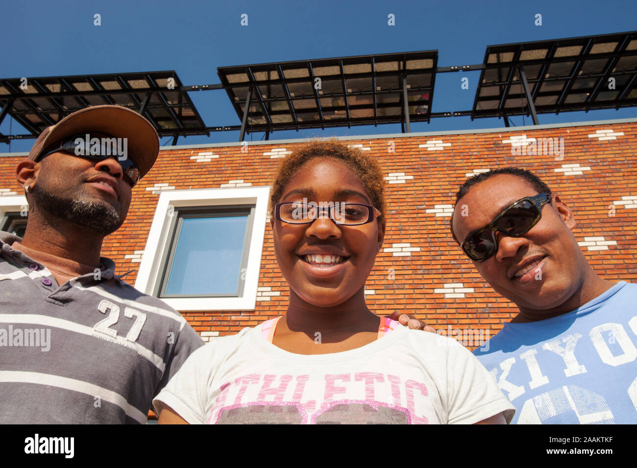 A family in front of their house in Almere with solar PV panels on the ...