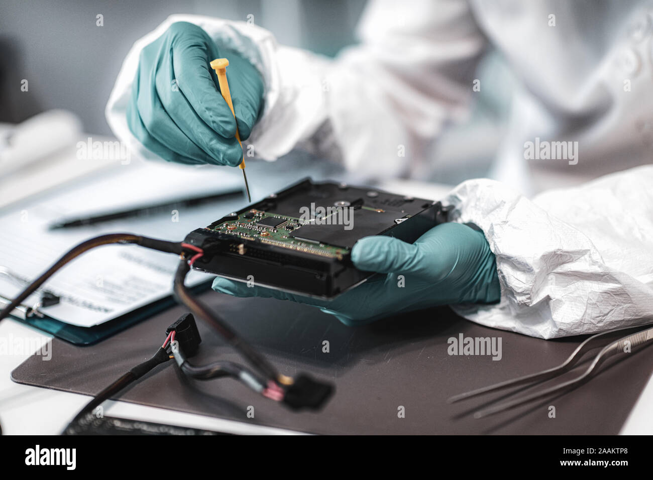 Forensic science investigator examining computer hard drive. Digital ...