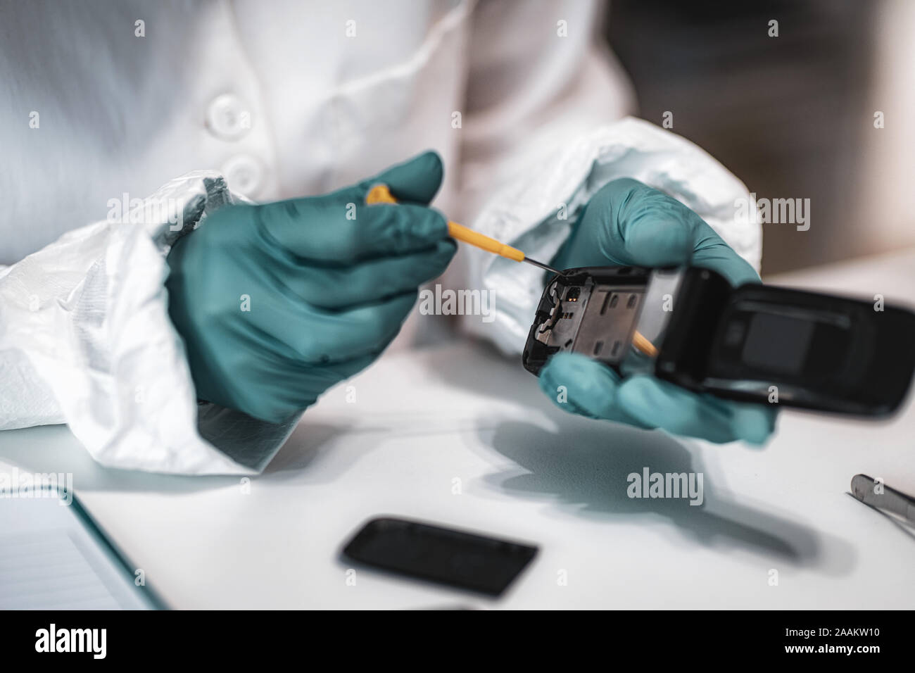 Digital forensic science. Police forensic analyst examining confiscated ...