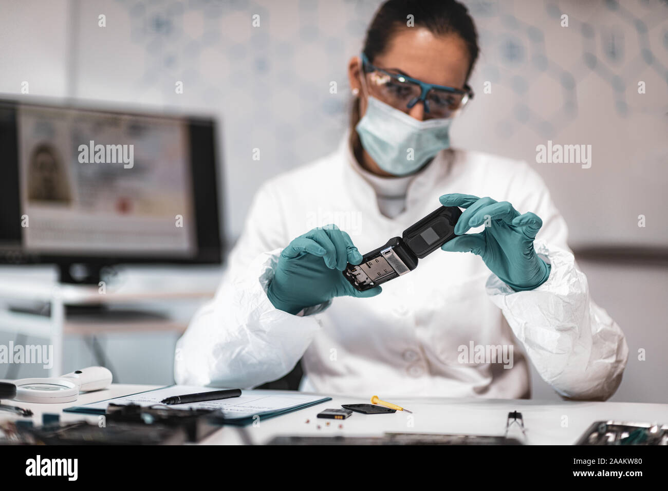 Digital forensic science. Police forensic analyst examining confiscated ...