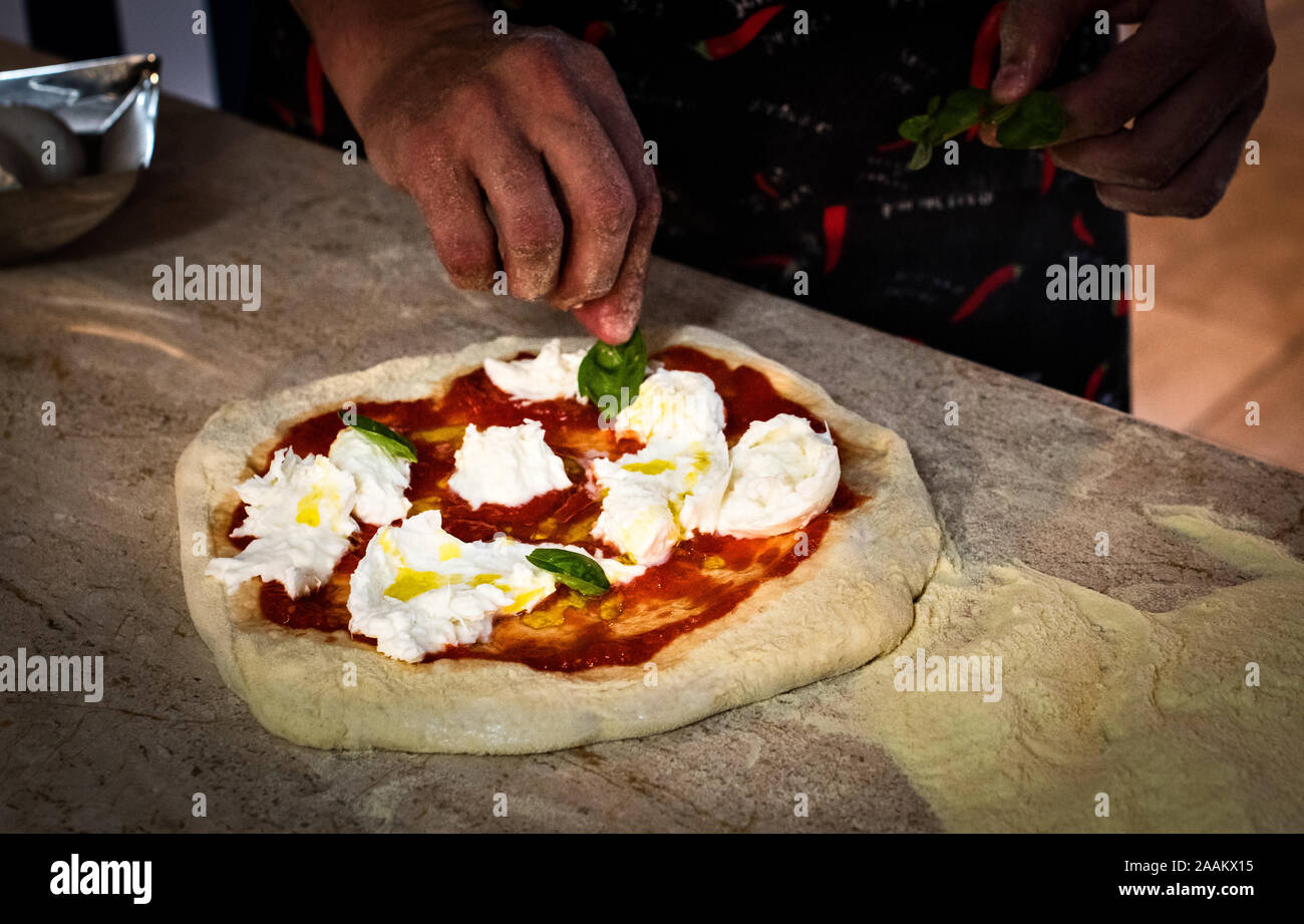 Chef preparing pizza in kitchen Stock Photo - Alamy