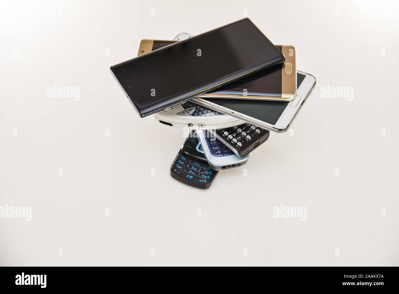 Mobile phones piled up in a spiral form showing the evolution back from ...