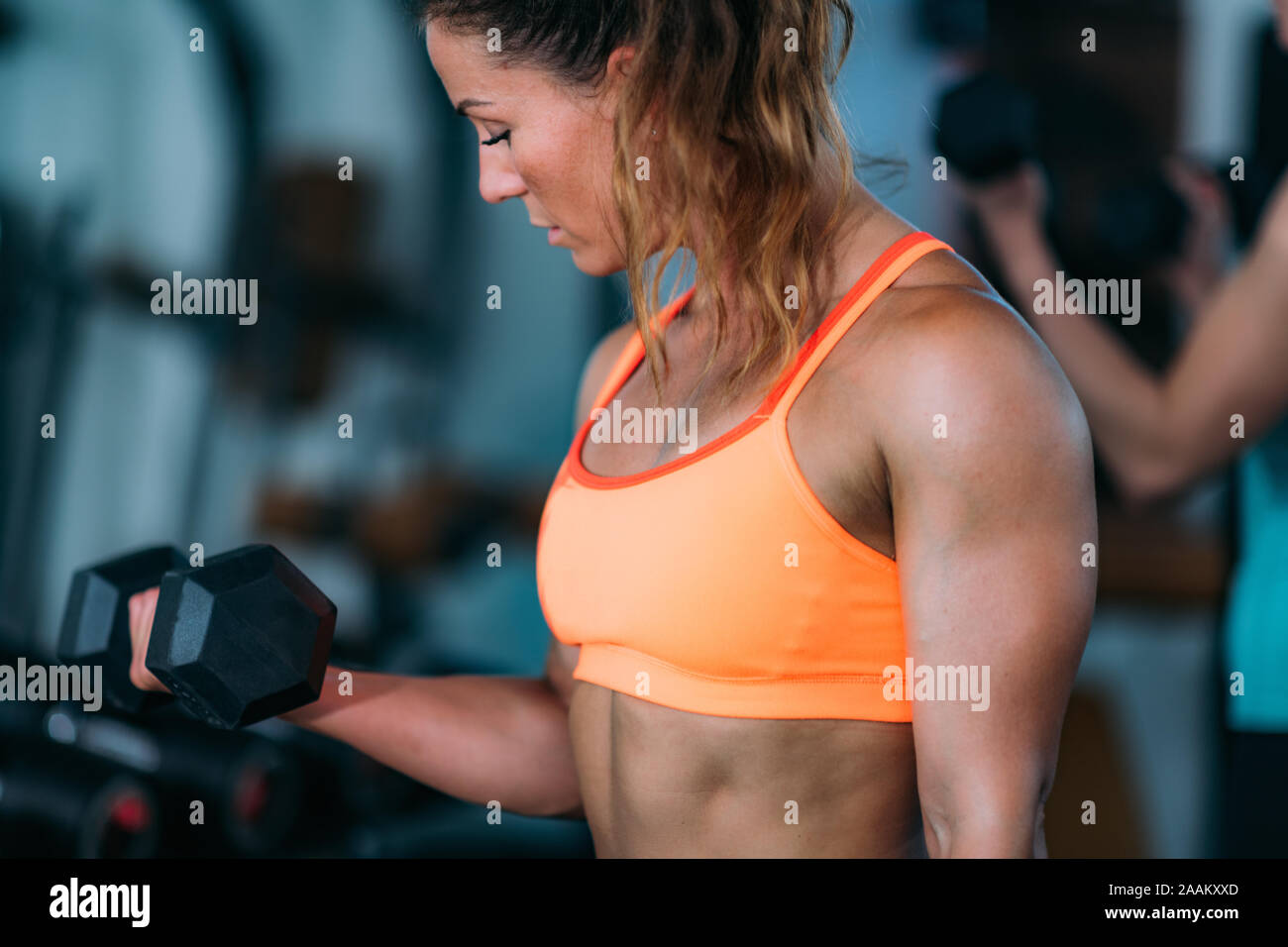 Woman doing biceps exercise with weights Stock Photo - Alamy