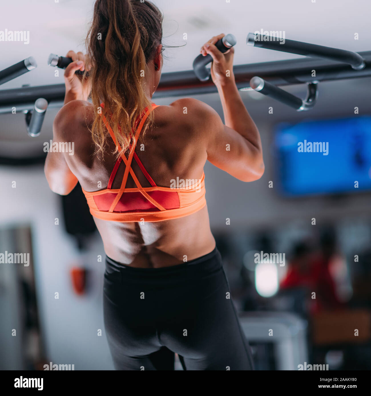 Female athlete doing pull-ups in the gym Stock Photo - Alamy
