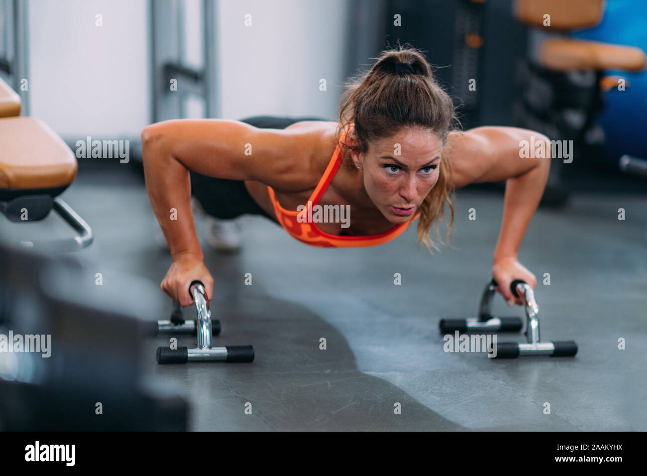 Female athlete doing push-ups in the gym Stock Photo - Alamy