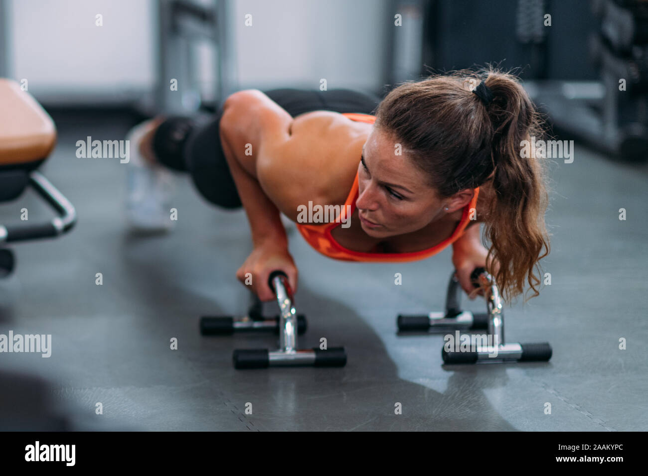 Female athlete doing push-ups in the gym Stock Photo - Alamy