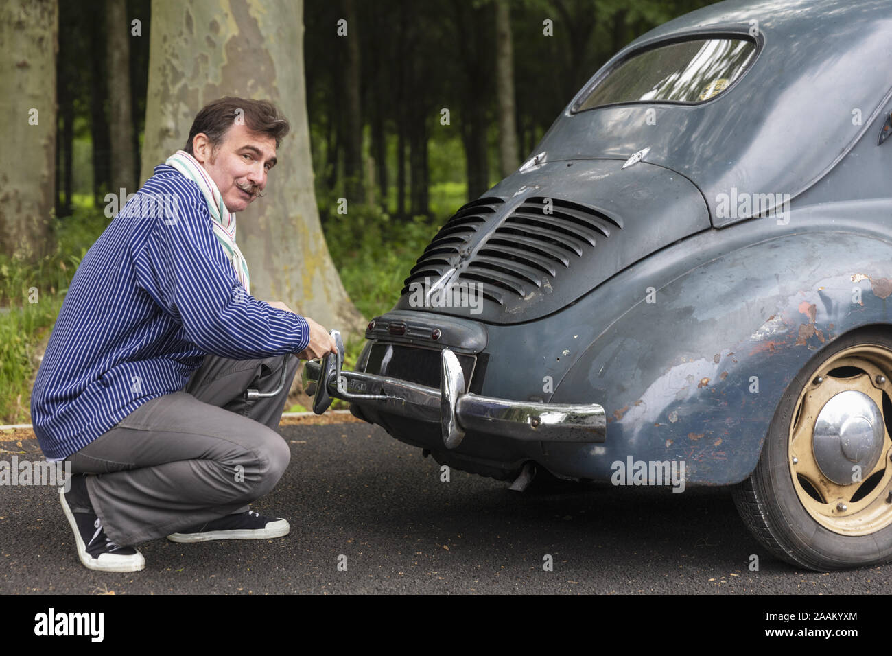 Man repairing car on road hi-res stock photography and images - Alamy