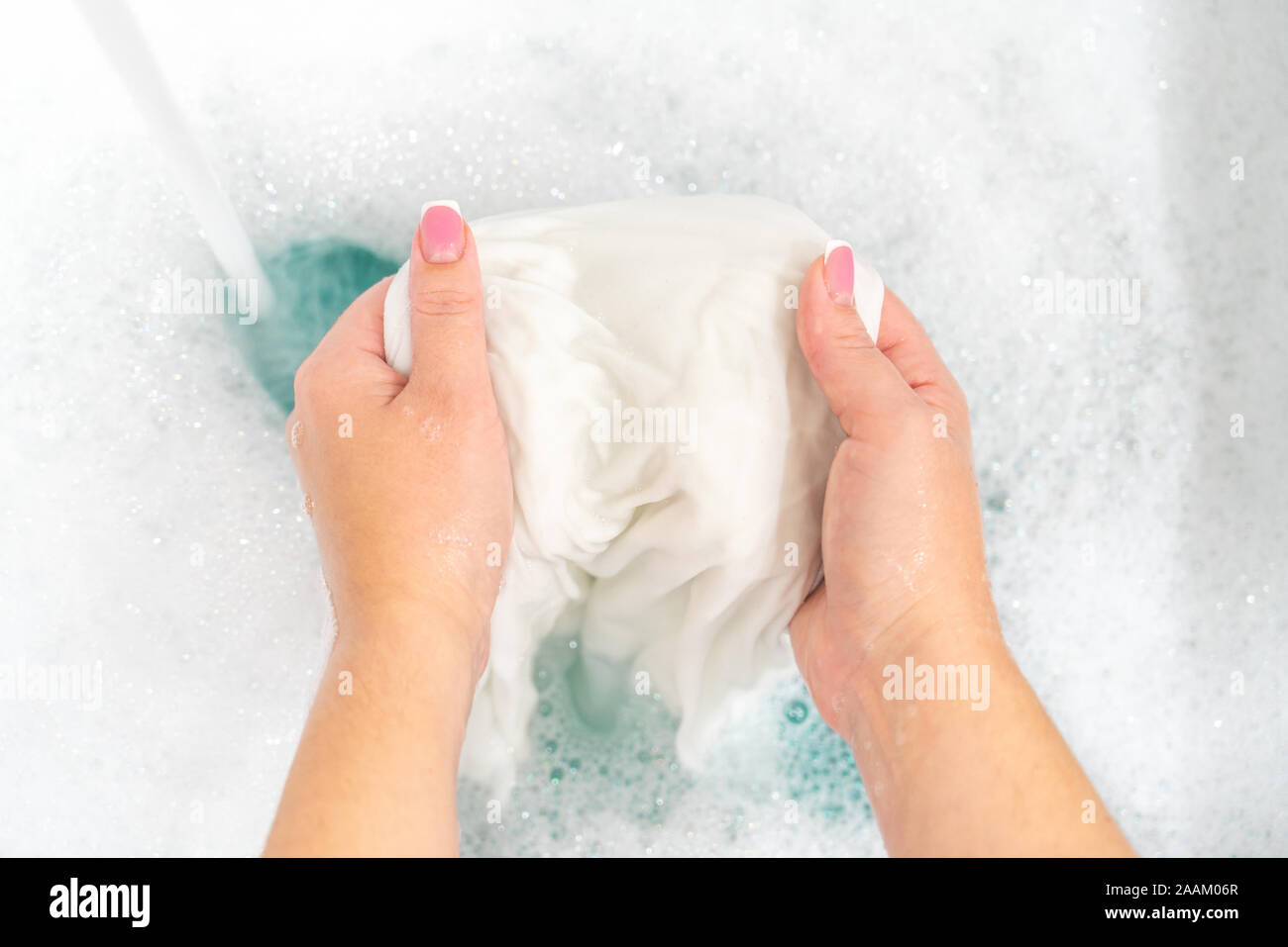 Female hands washing color clothes in basin Stock Photo - Alamy