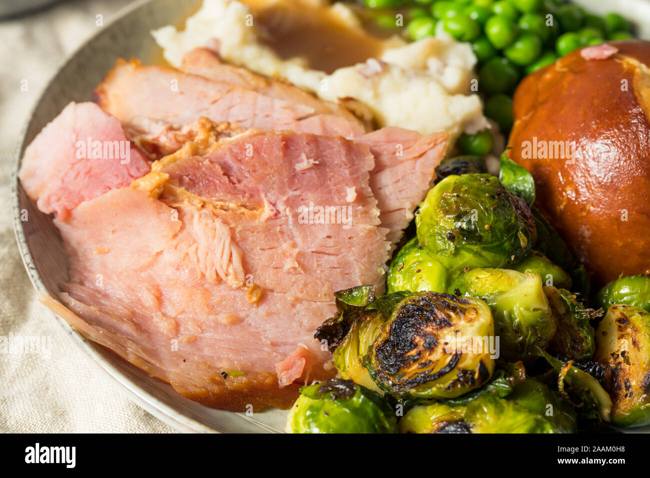 Homemade Glazed Holiday Ham Roast with All the Sides Stock Photo - Alamy