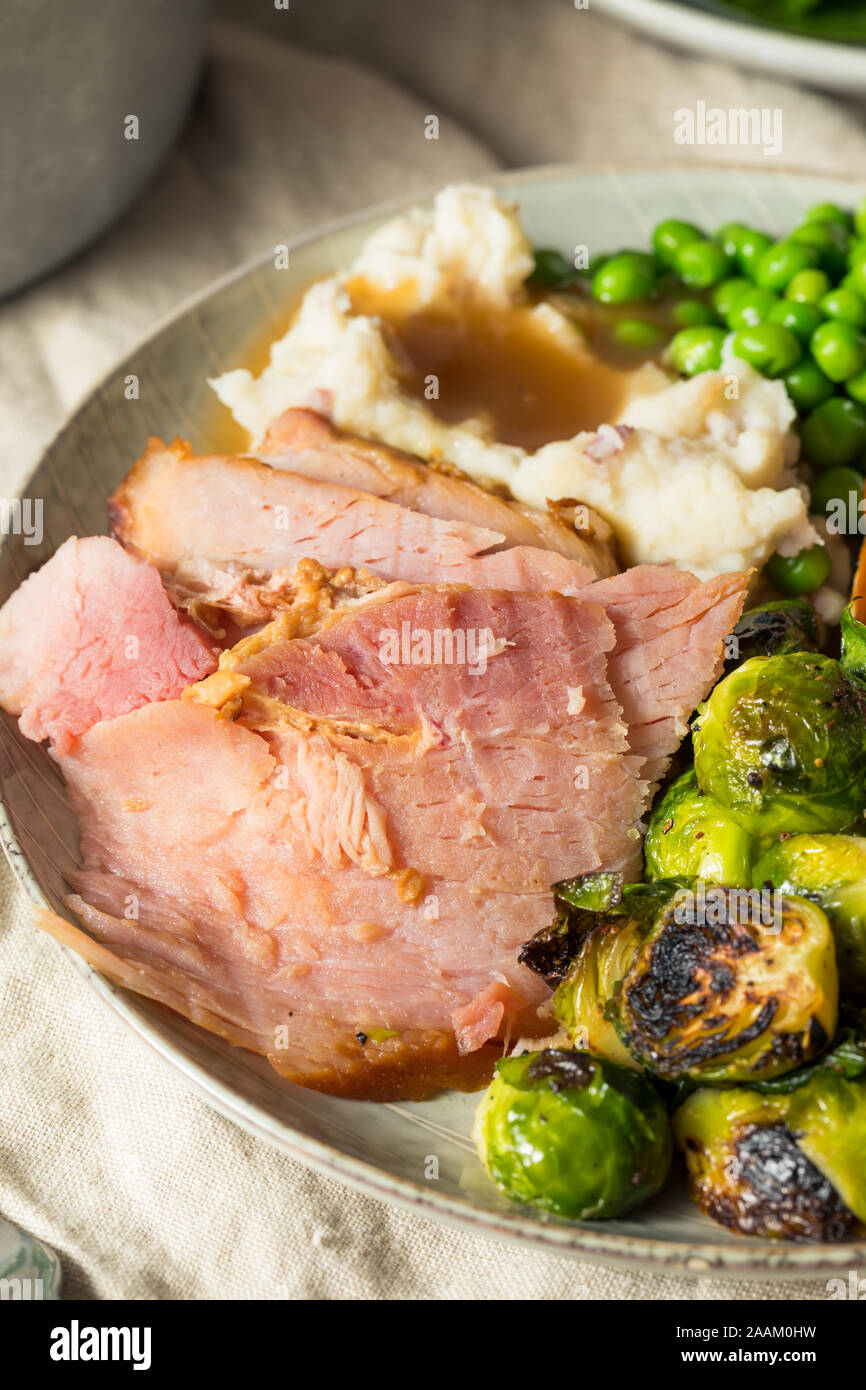 Homemade Glazed Holiday Ham Roast with All the Sides Stock Photo - Alamy