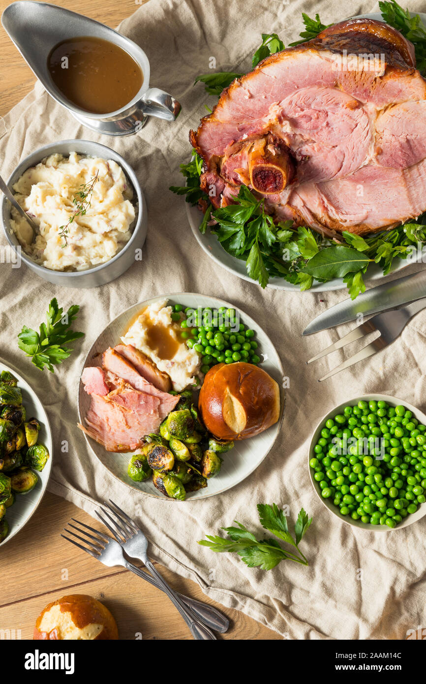 Homemade Glazed Holiday Ham Roast with All the Sides Stock Photo - Alamy