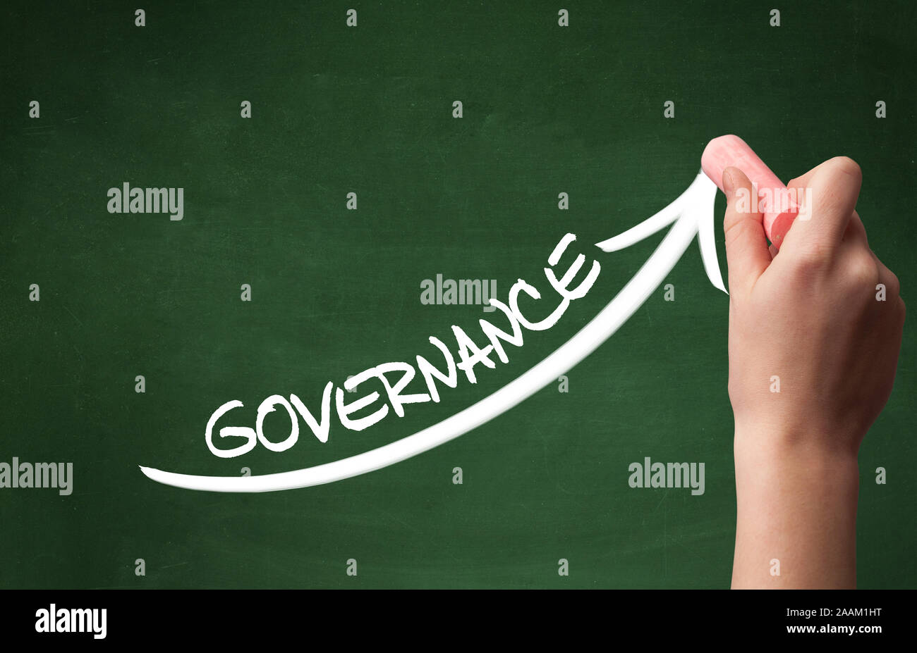 Hand drawing GOVERNANCE inscription with white chalk on blackboard ...