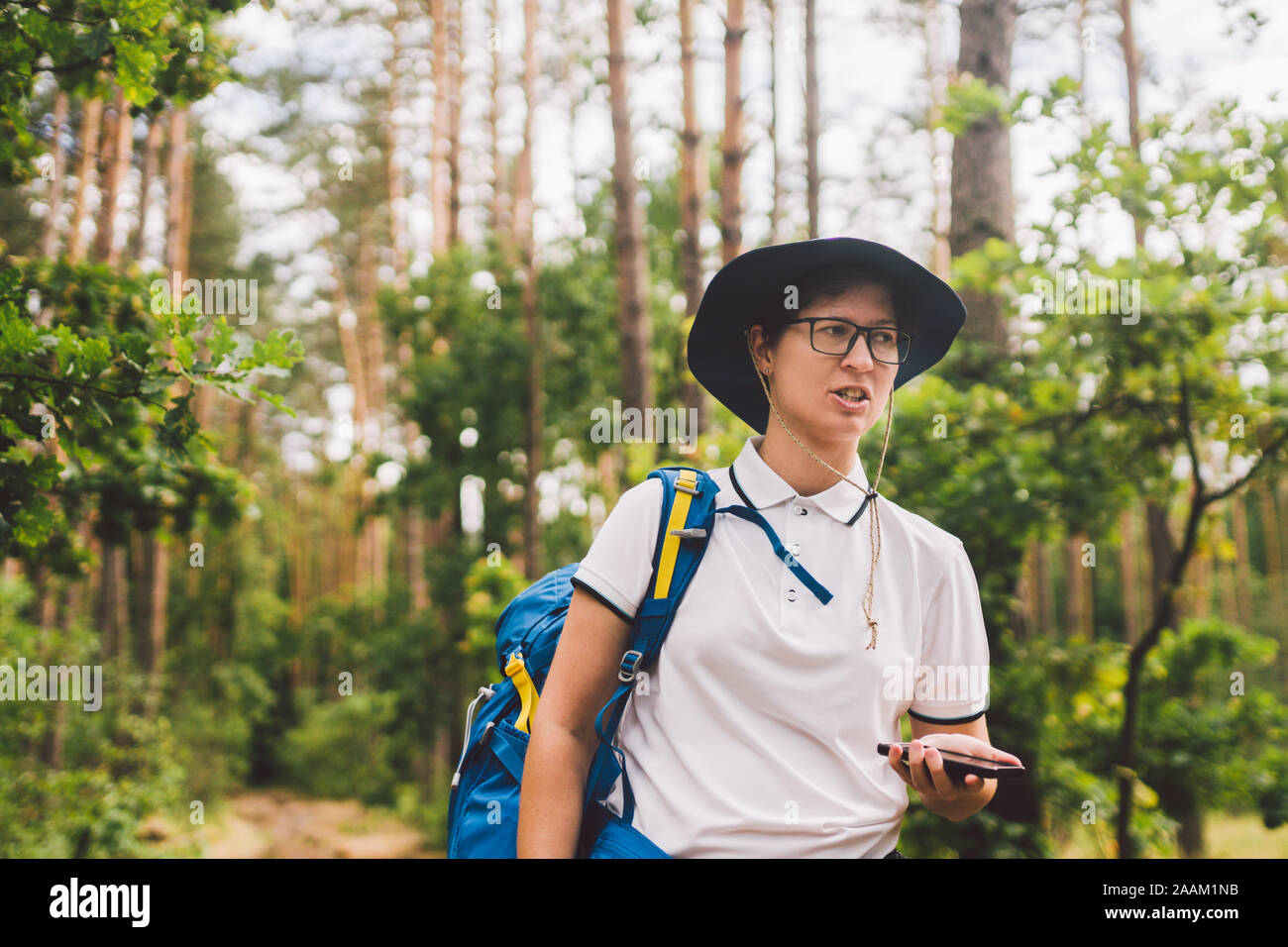 Girl tourist use smartphone on hike, looks maps and navigation. Woman ...