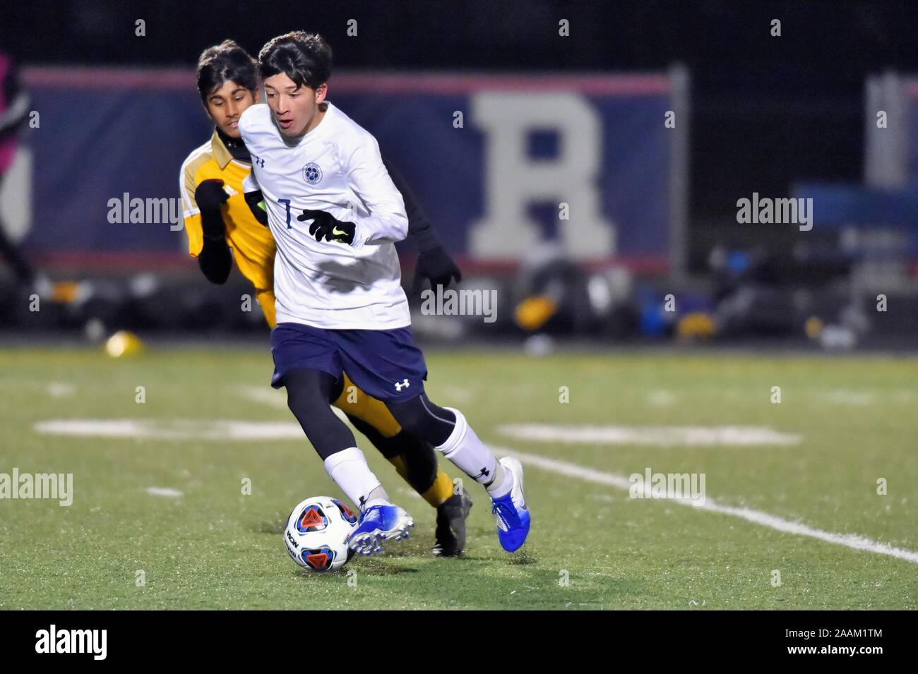 Forward leading a rush while pursued by an opposing defender. USA Stock ...