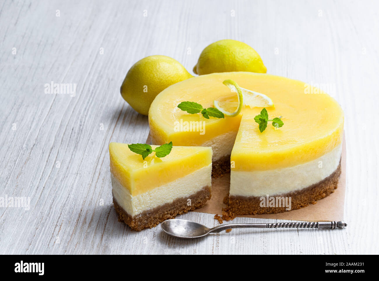 Homemade Layered Lemon Cheesecake on white wooden table Stock Photo - Alamy