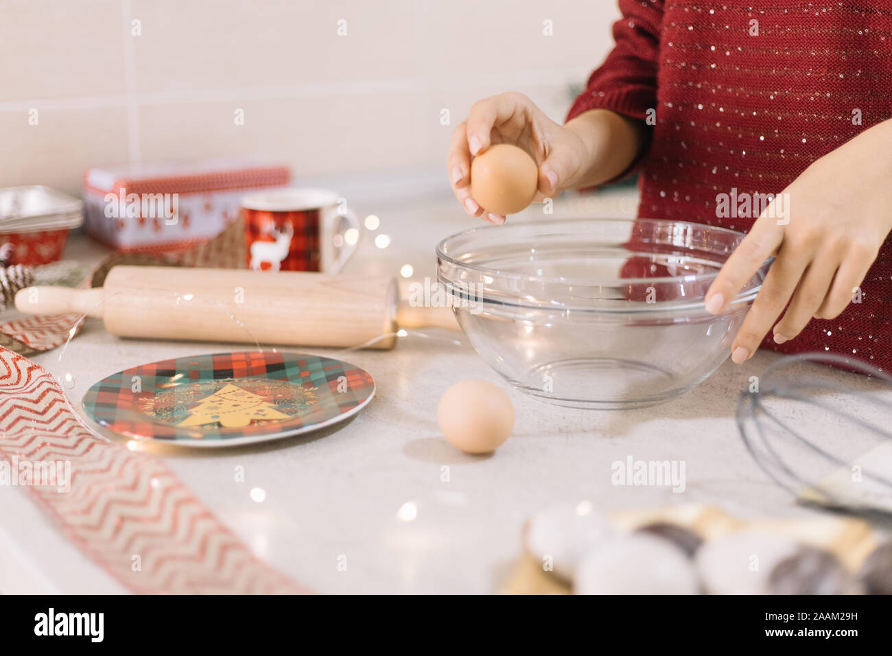 Close-up of woman breaking egg into a bowl Stock Photo - Alamy