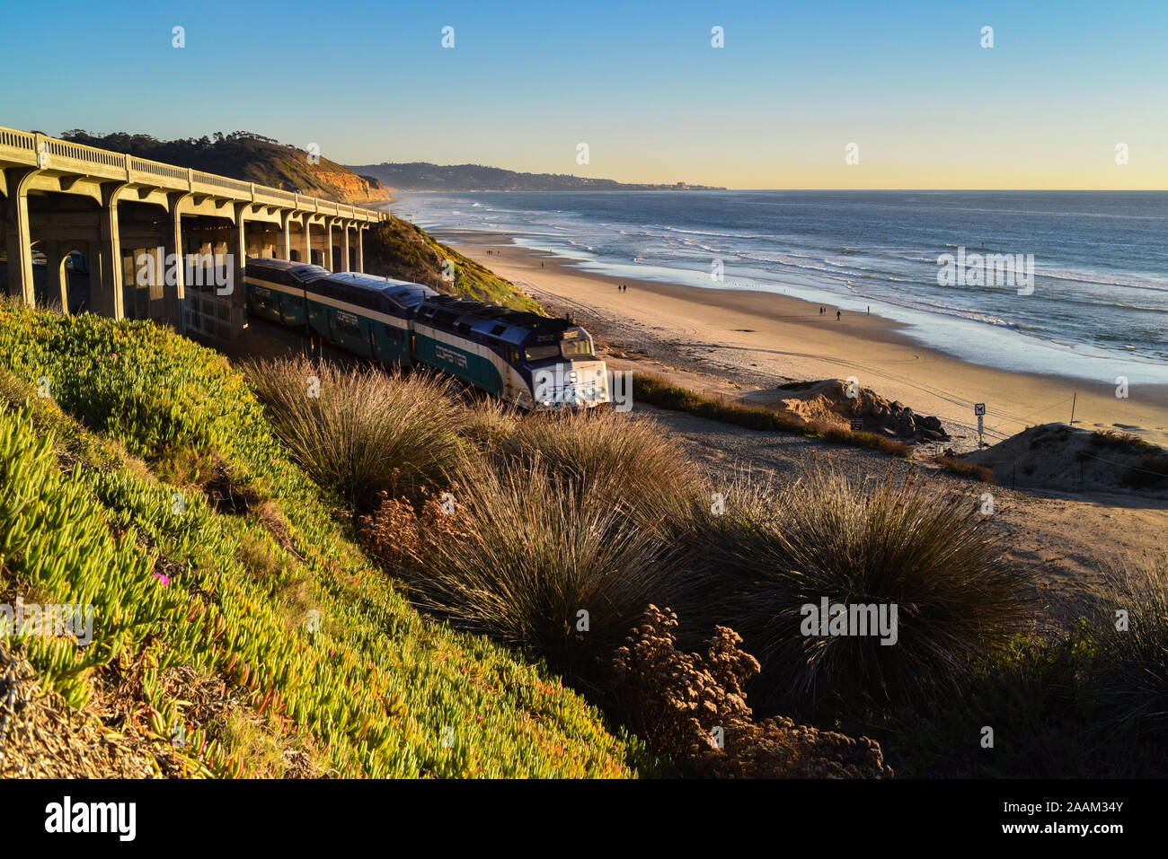 Coaster passenger diesel locomotive traveling along coastal railroad ...