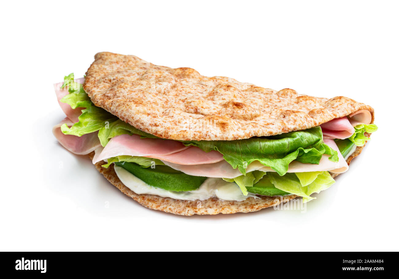 Folded wholemeal flatbread with ham and vegetables isolated on white ...