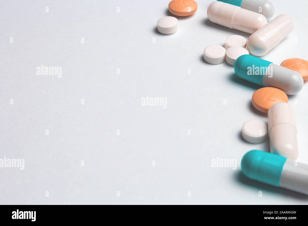 Blue, orange and white pills frame corner on white background Stock ...