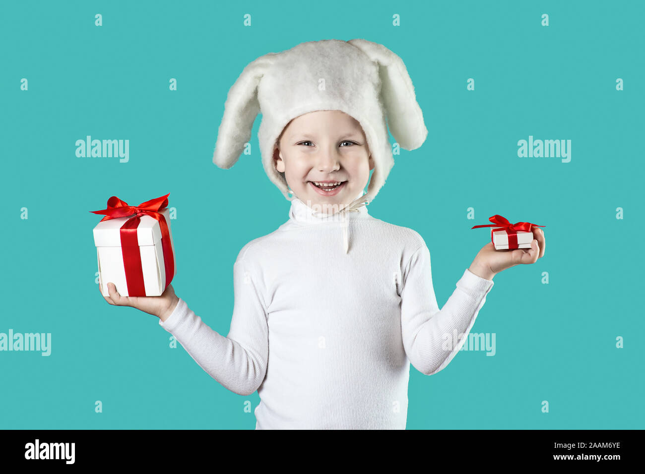 a boy dressed as a white hare tries to choose a gift on a mint ...