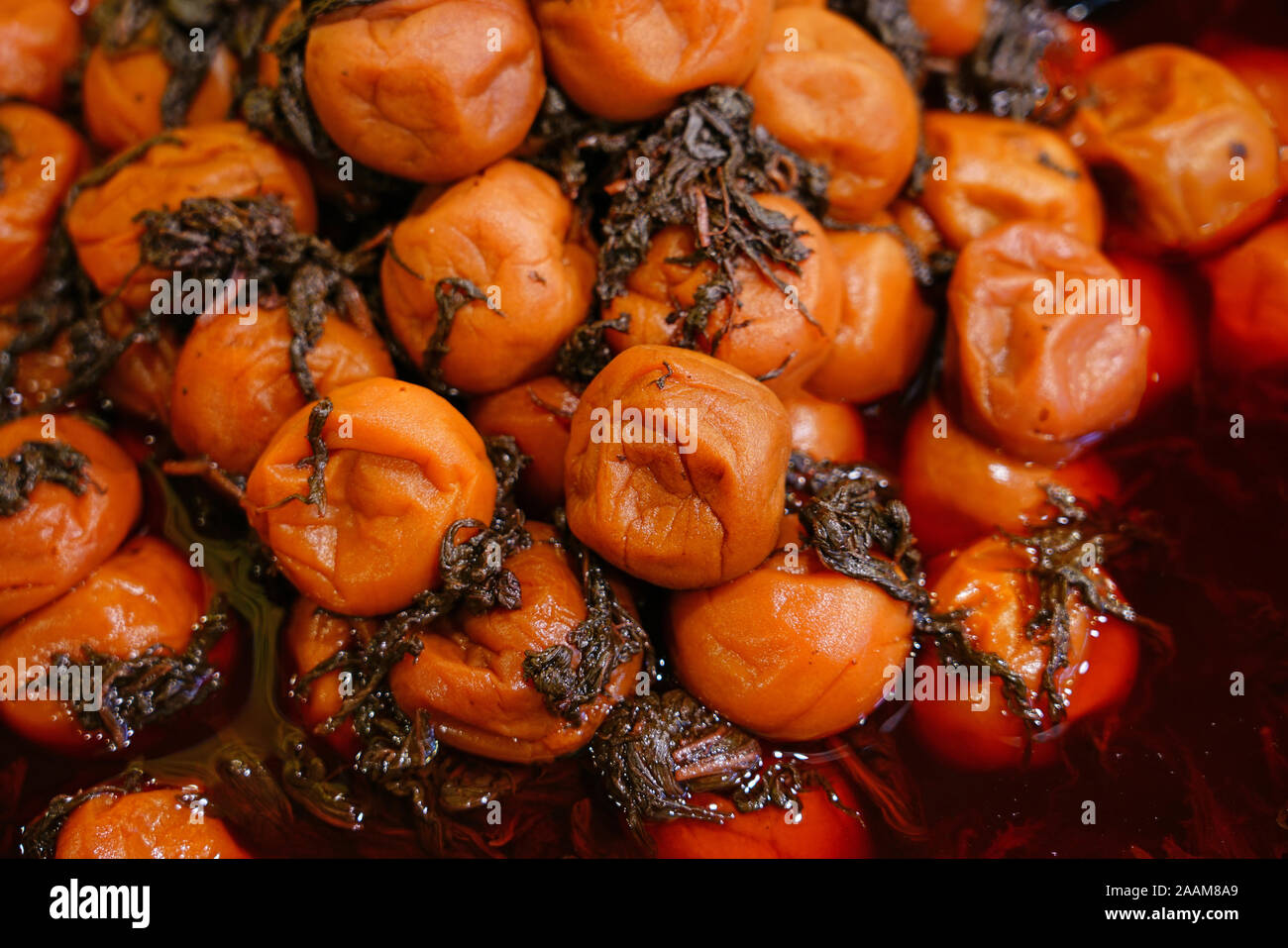Pink umeboshi pickled ume plums with shiso Stock Photo - Alamy